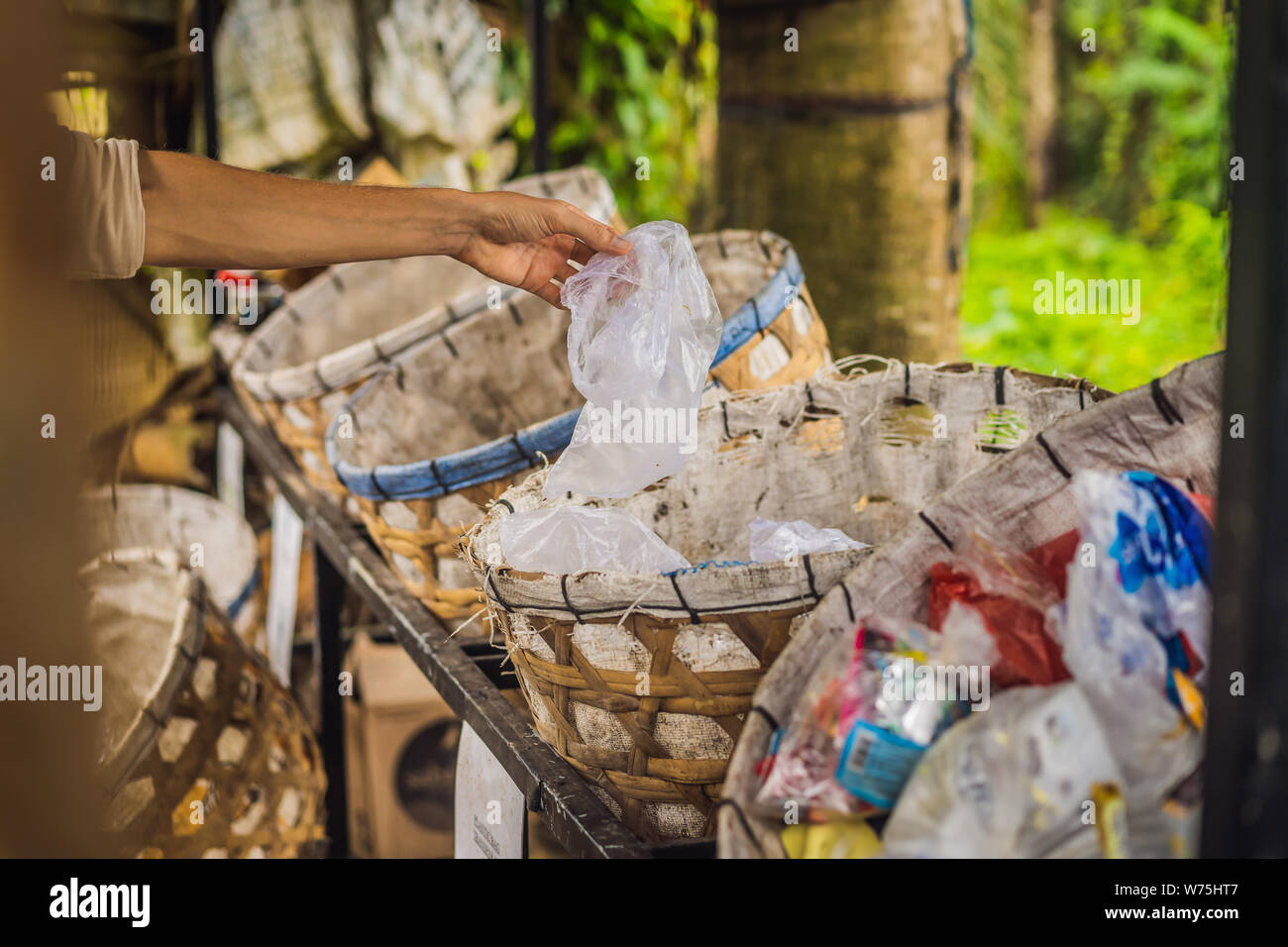 Man separately picks up trash. Separate garbage collection concept ...