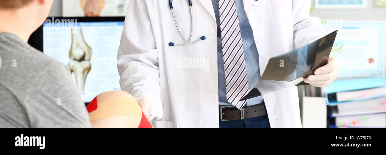 Serious physician with man Stock Photo - Alamy