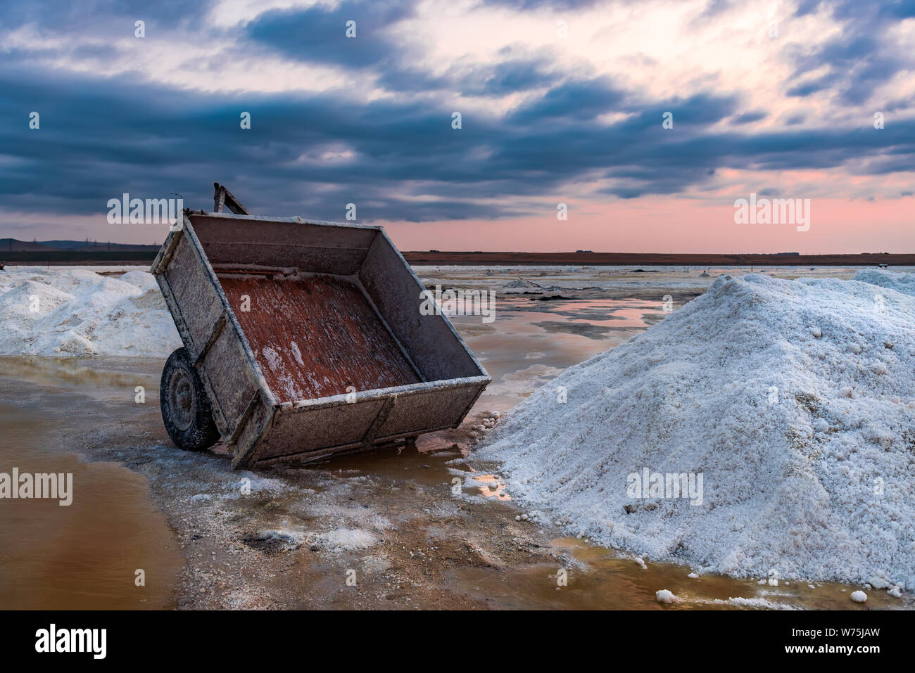 Salt mining on the lake during sunset Stock Photo - Alamy