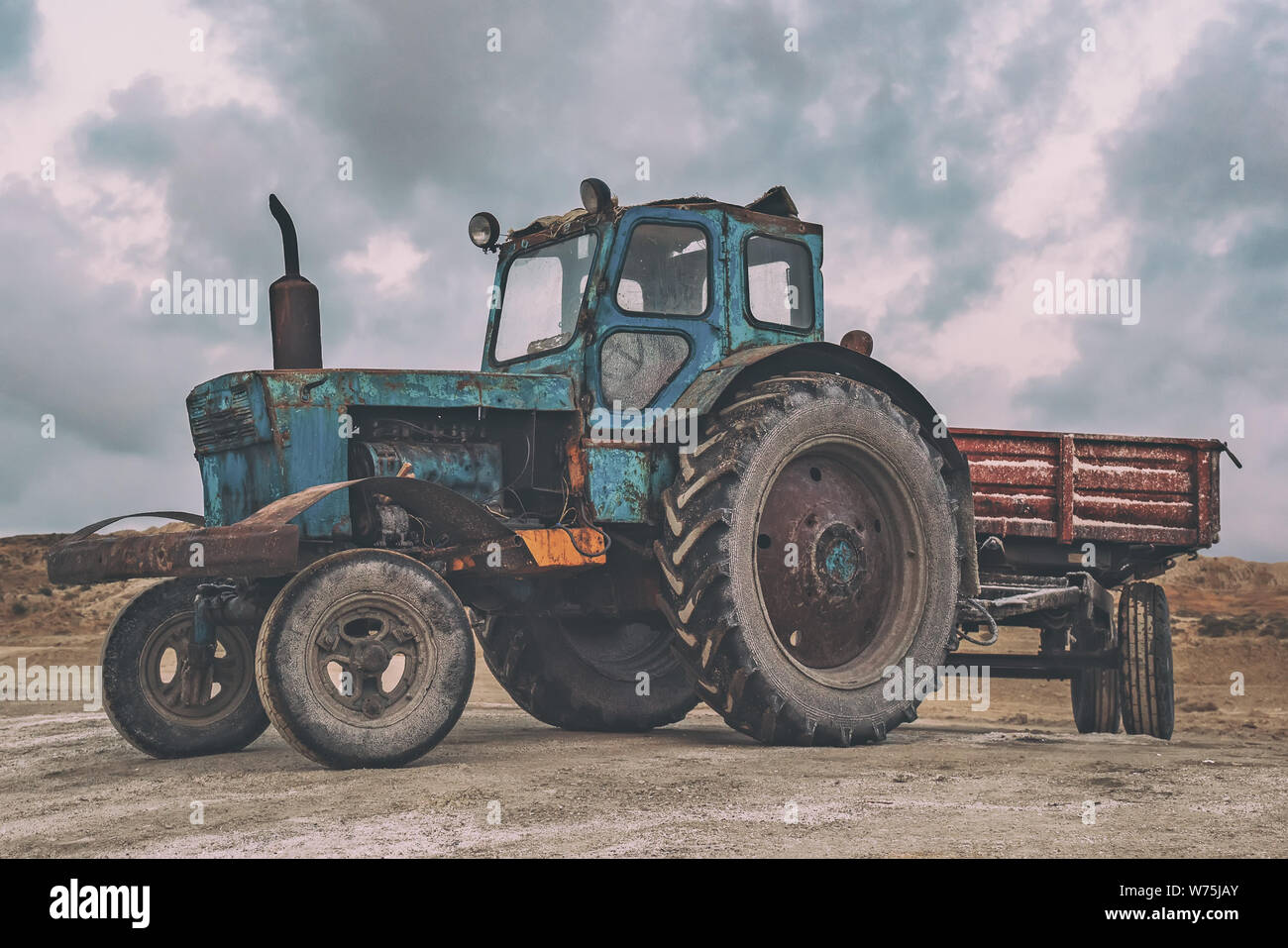 Old rusty abandoned tractor with trailer Stock Photo - Alamy