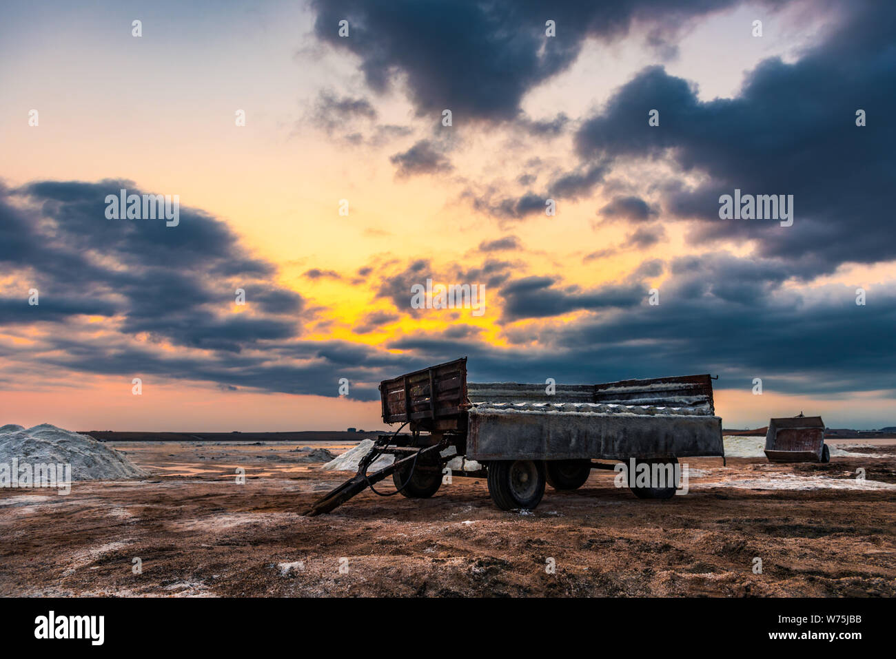 Salt mining on the lake during sunset Stock Photo - Alamy
