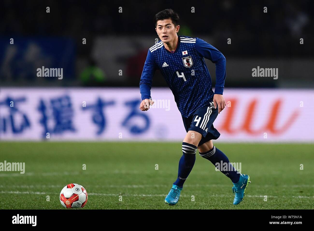 Shogo Taniguchi of Japan dribbles against North Korean during the EAFF ...