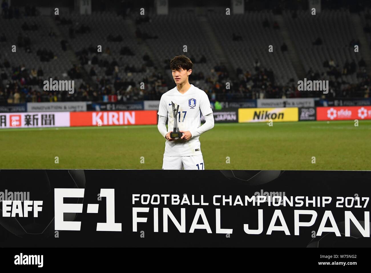 Lee Jaesung of South Korea poses on the podium after defeating Japan ...
