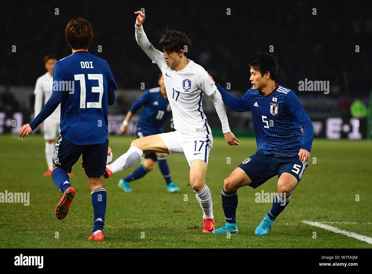 Lee Jaesung of South Korea, center, challenges Shoma Doi, left, and ...