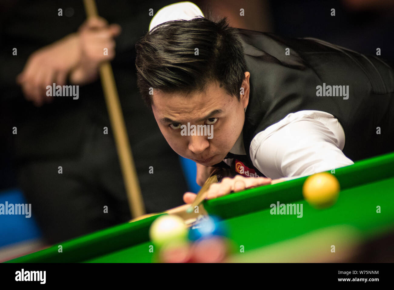 Xiao Guodong of China plays a shot to Neil Robertson of Australia in ...
