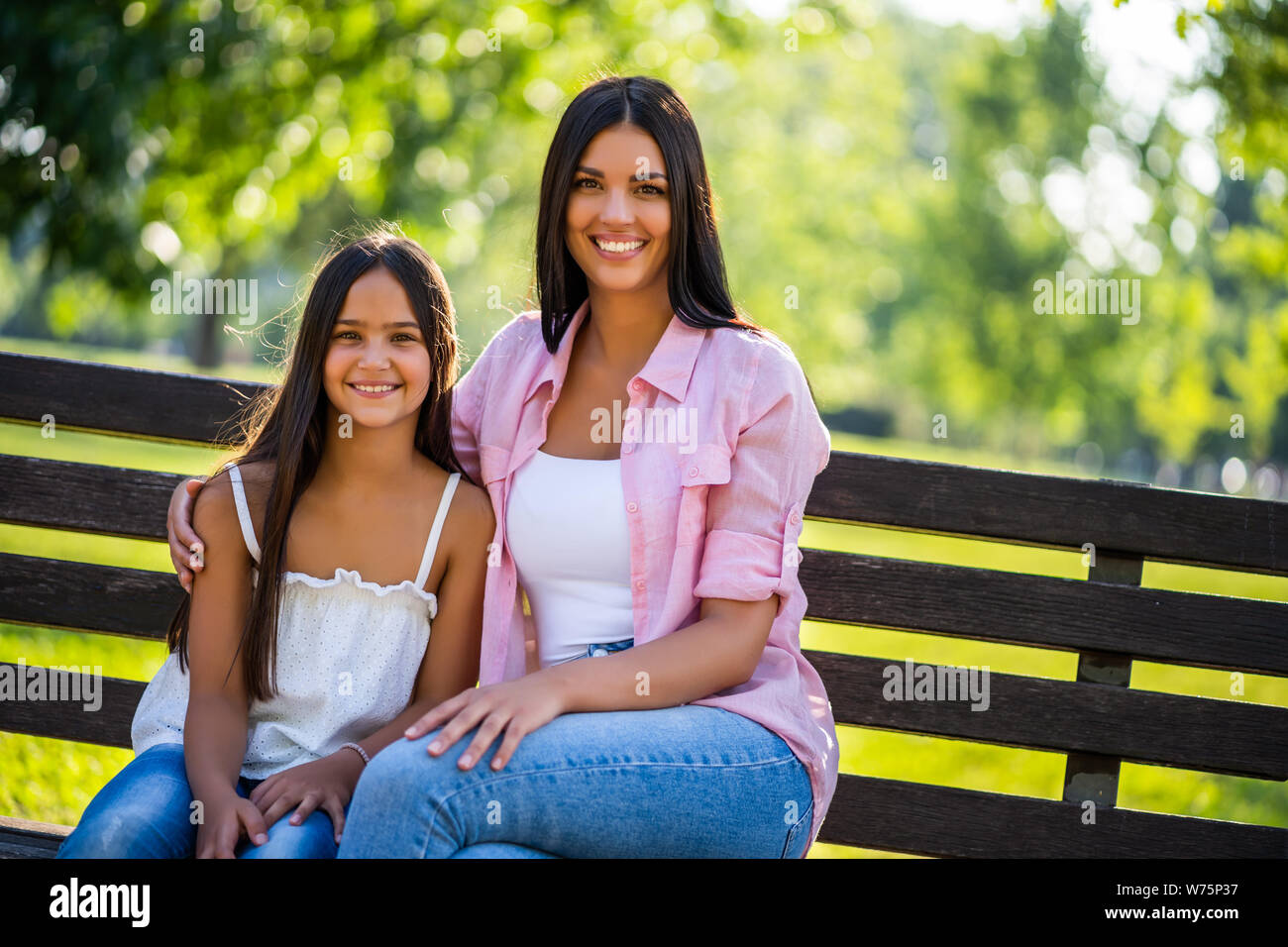 Happy family having nice time in park together Stock Photo - Alamy