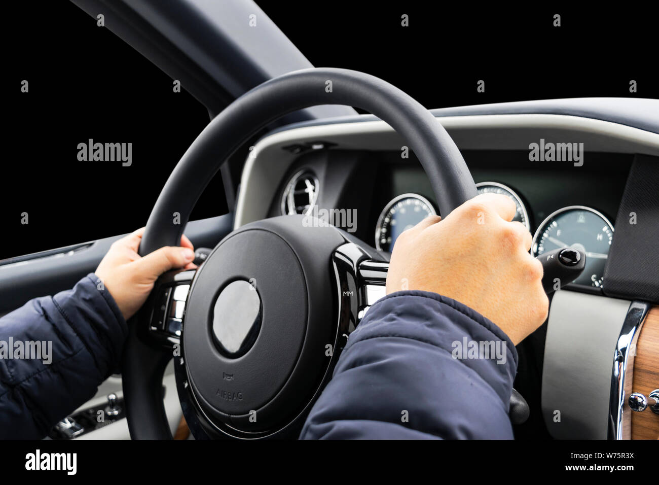 Male hands holding car steering wheel. Hands on steering wheel of a car ...