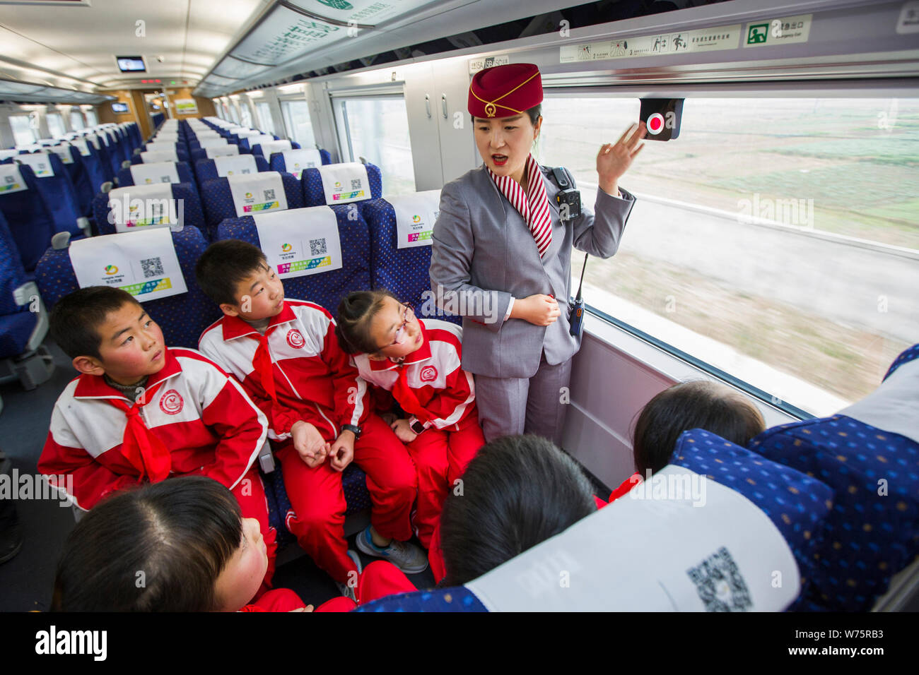 A train attendant talks with young Chinese students in a CHR (China ...
