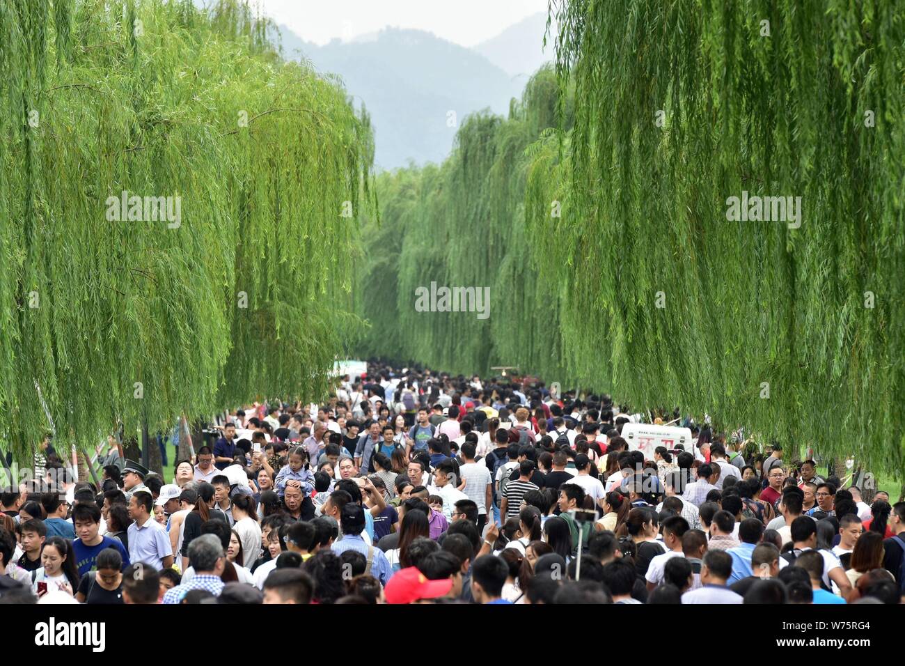 --FILE--Tourists crowd the promenade along the West Lake during the ...