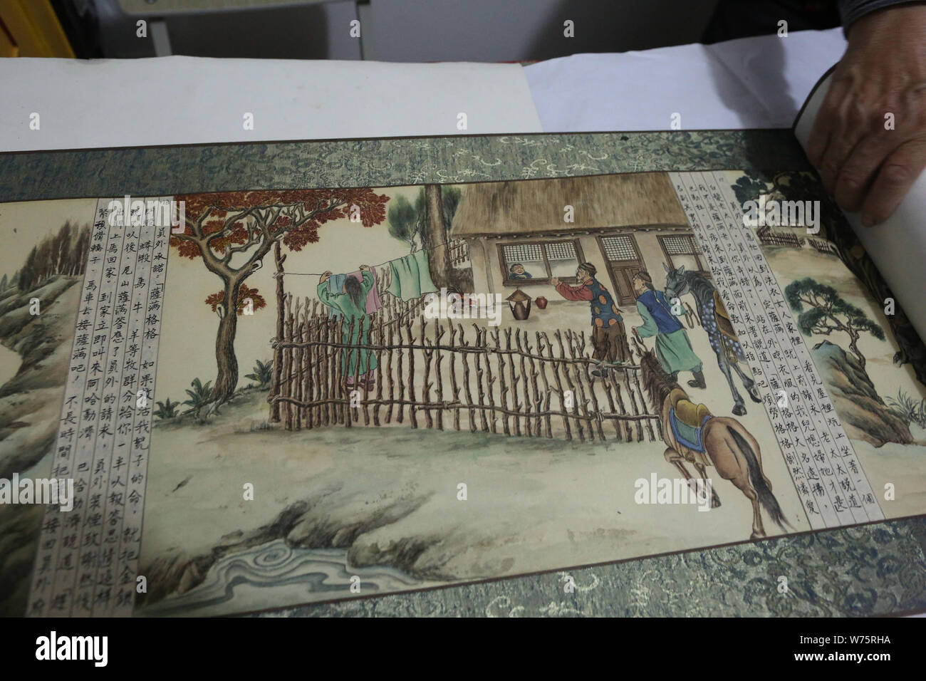 63-year-old retired Chinese teacher Yuan Xihe shows a six-meter-long ...