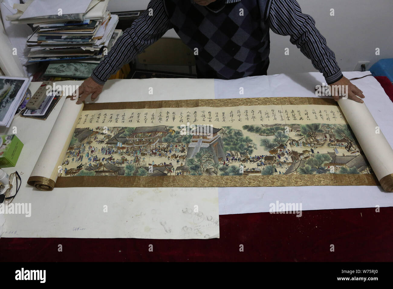 63-year-old retired Chinese teacher Yuan Xihe shows a six-meter-long ...