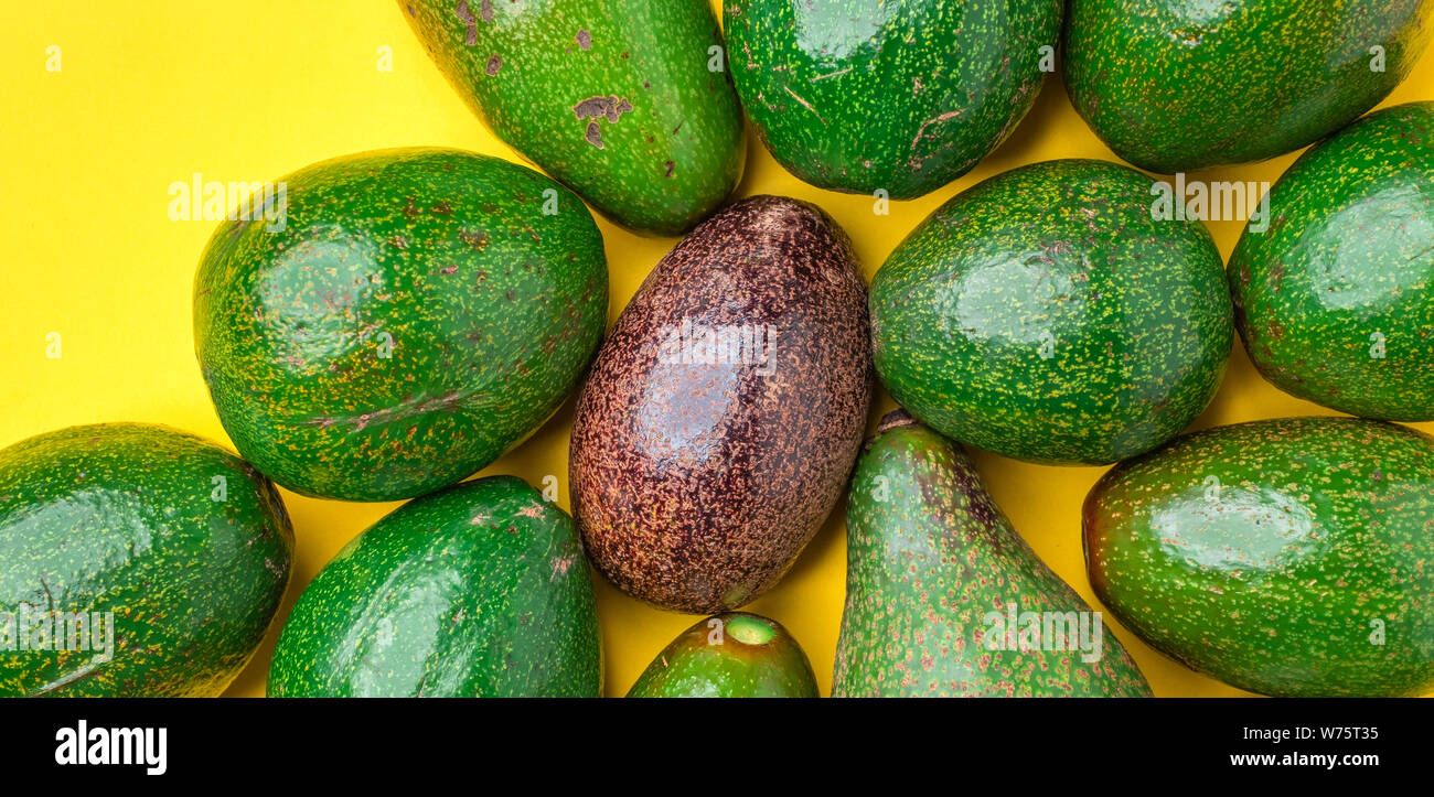 close up red organic avocado in group of green avocados healthy food on ...