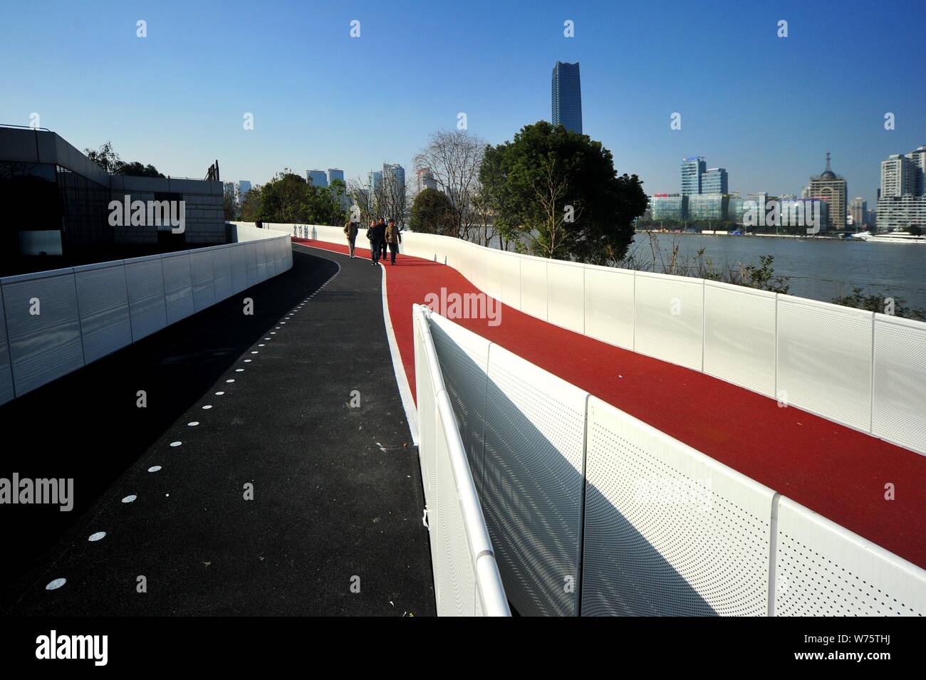 Local residents walk on the jogging track of a greenway belt system in ...