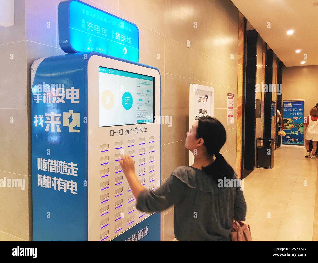 --FILE--A local resident rents a phone charger of phone charger sharing ...