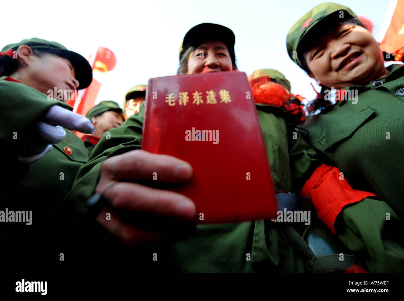 Chinese people in uniform present a "Selected Works of Mao Zedong" in ...