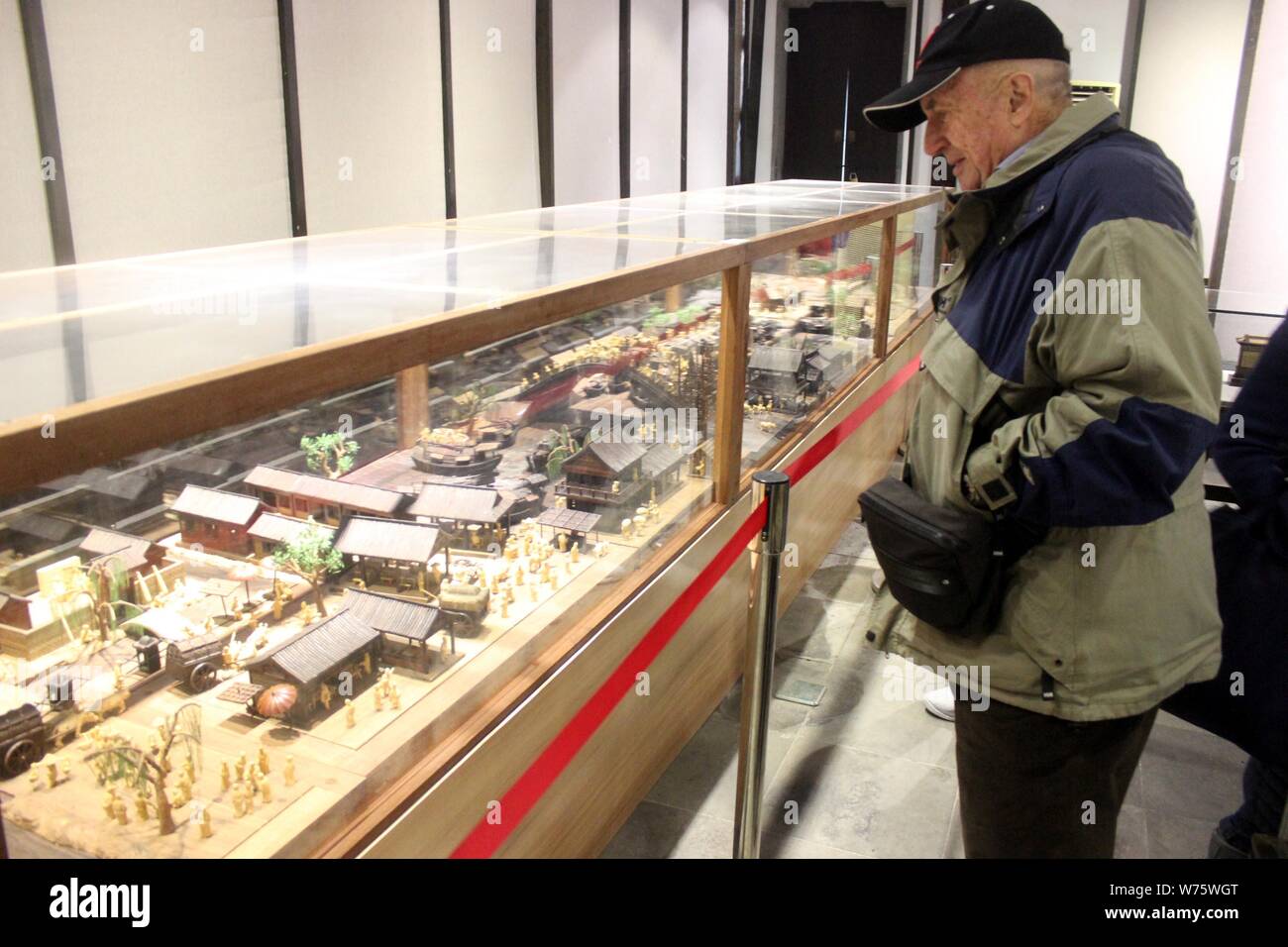A visitor looks at the microscopic carving "Riverside Scene at Qingming ...