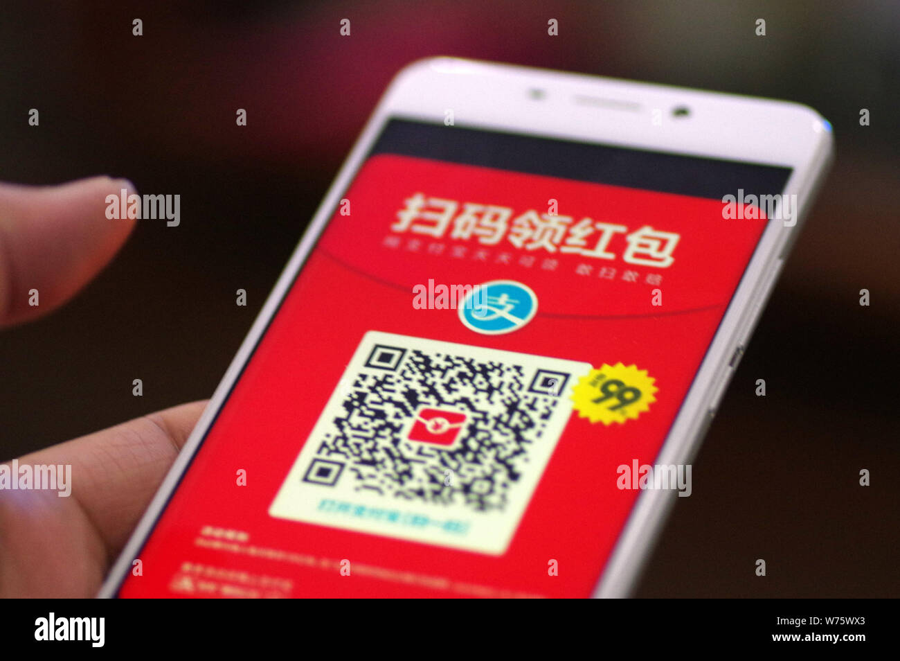 A Chinese mobile phone user scans a QR code via mobile payment service ...