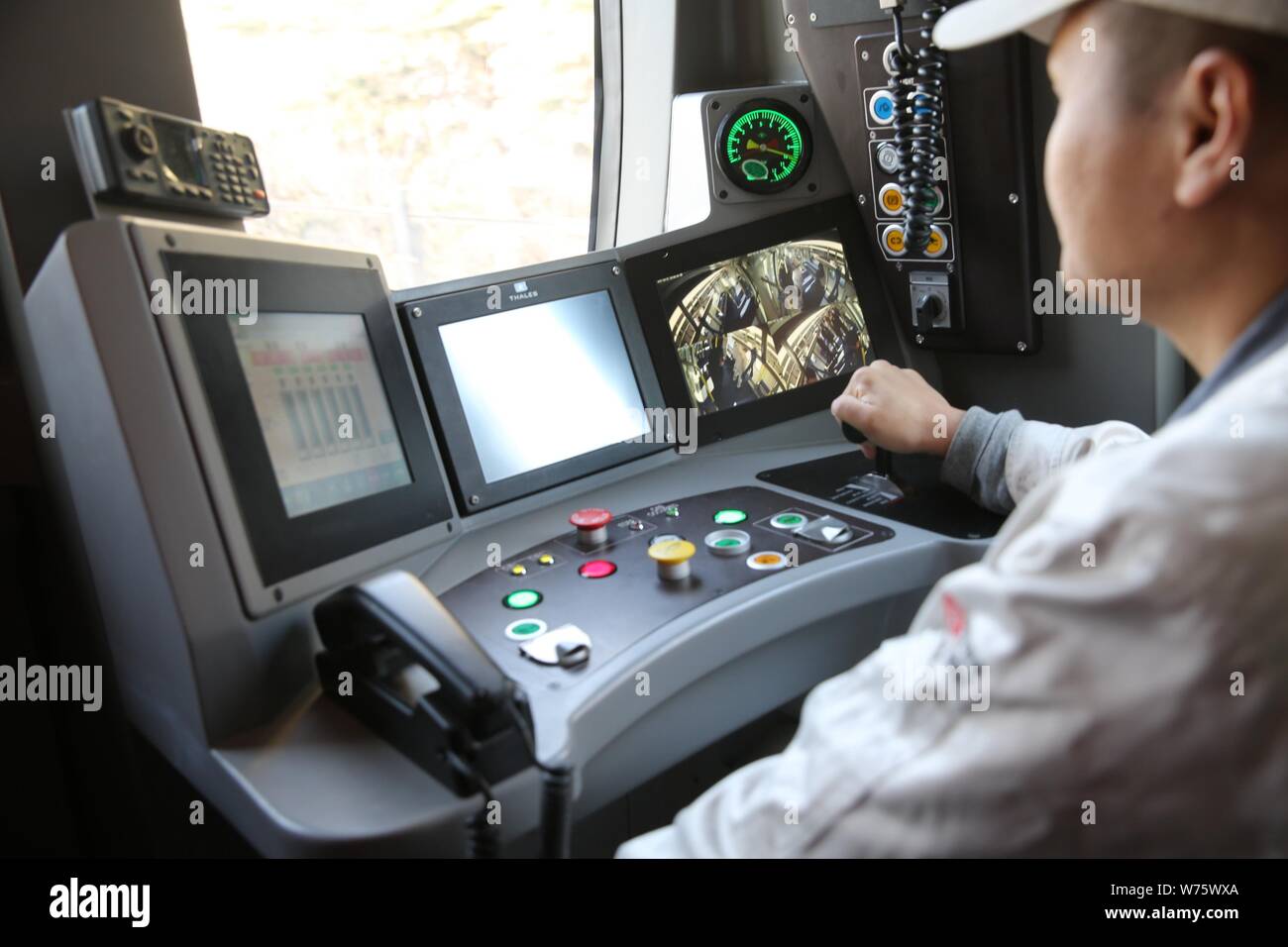 A driver operates a subway train for the Hong Kong transportation ...