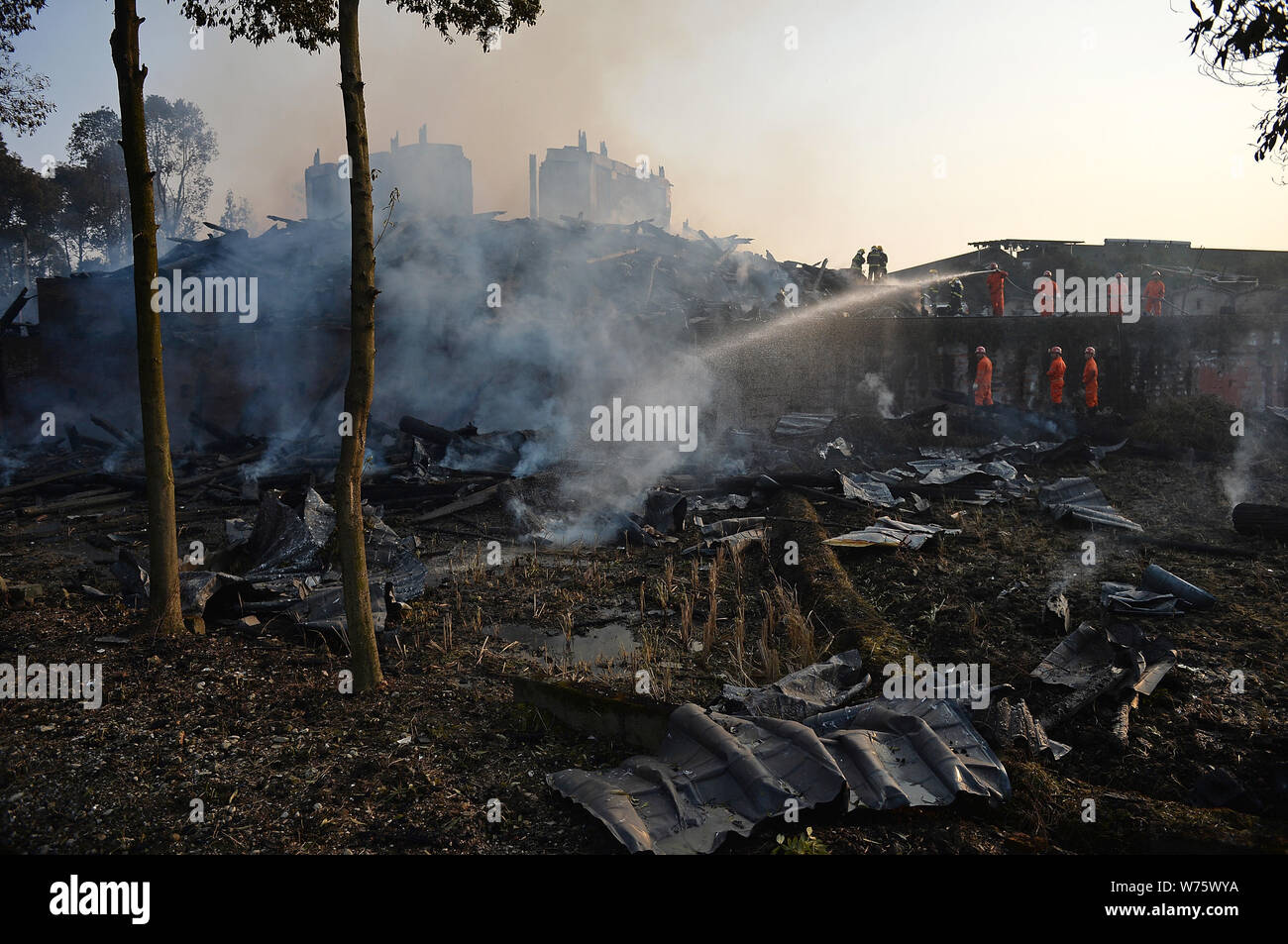 Firefighters hose water to extinguish fire in Asia's tallest wood ...