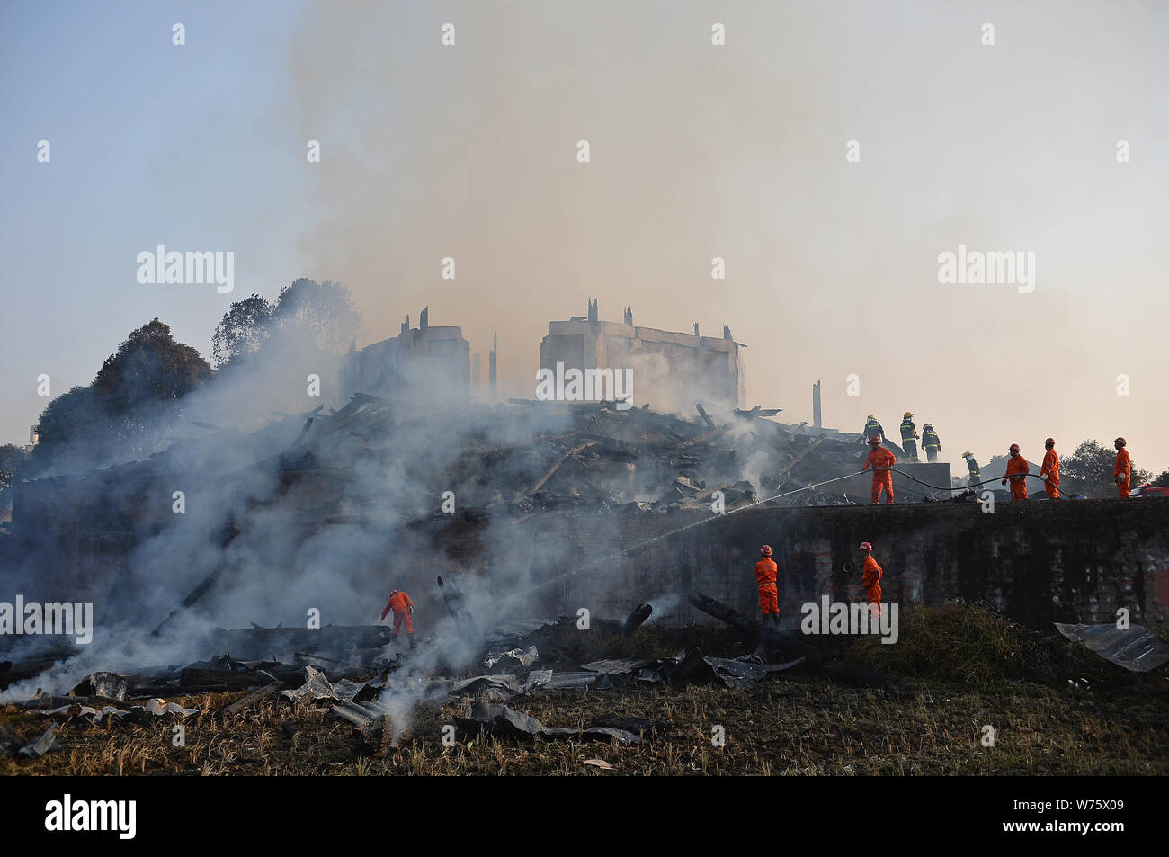 Firefighters hose water to extinguish fire in Asia's tallest wood ...