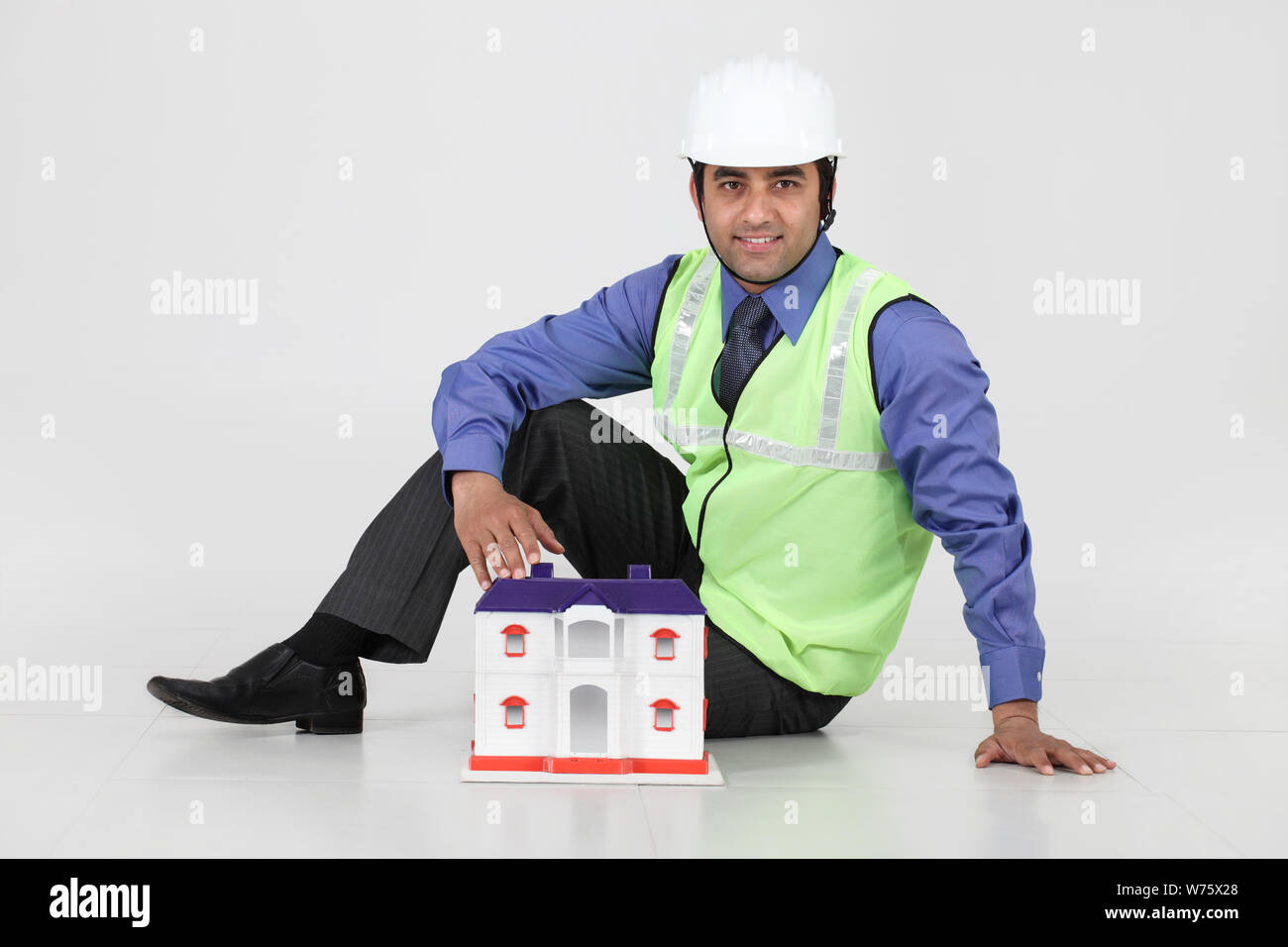 Architect showing model of dream home Stock Photo - Alamy