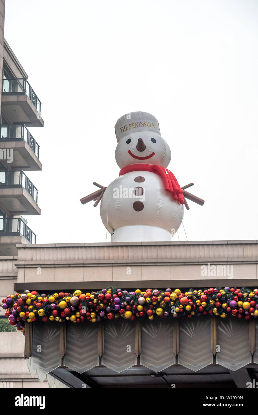 A snowman decoration is displayed on the rooftop of on the rooftop of ...