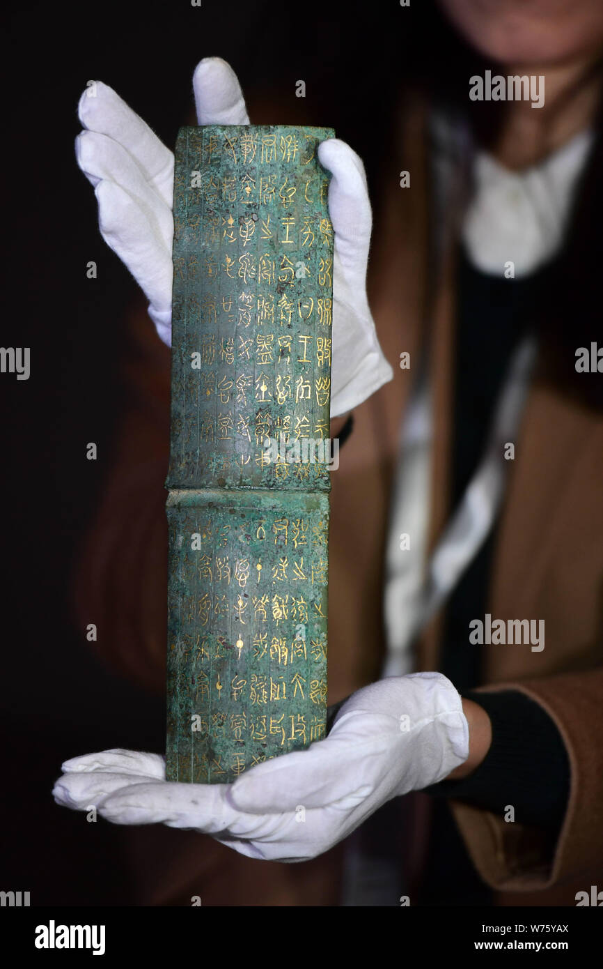 An employee displays a Bronze Tiger-shaped Tally of Qin Dynasty at the ...