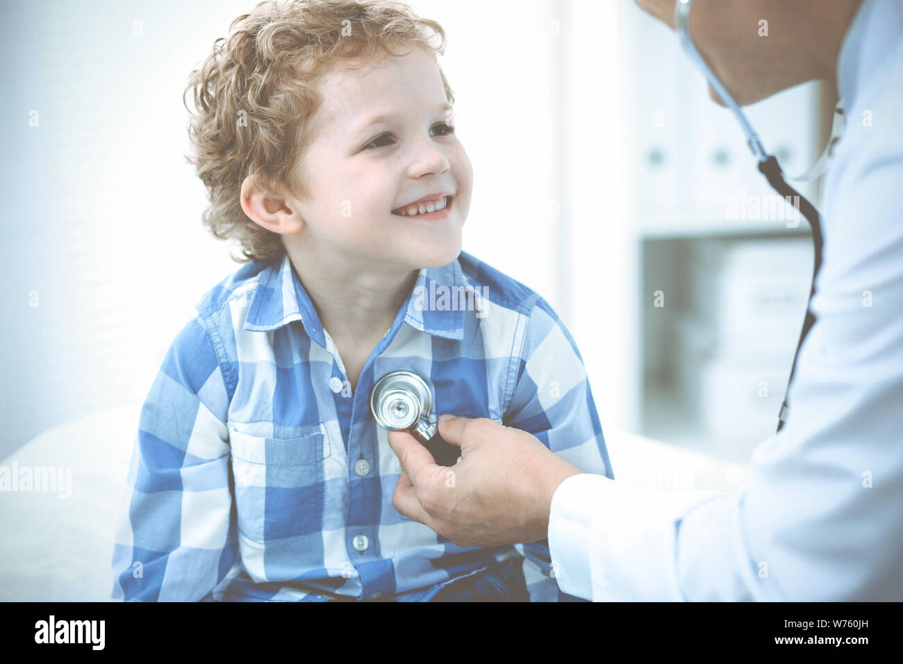 Doctor and patient child. Physician examining little boy. Regular ...