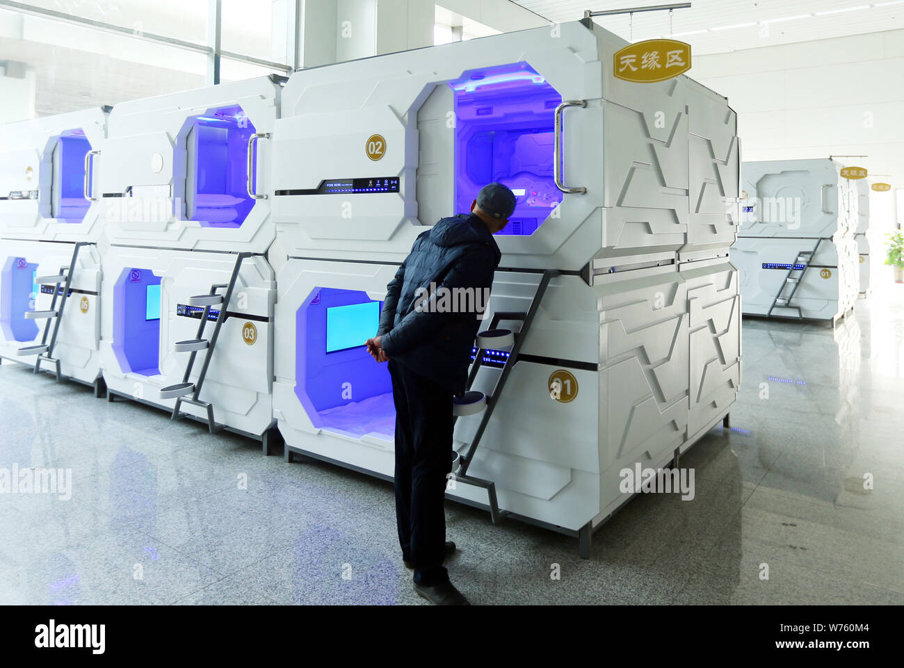 A passenger looks at sleeping capsules in the arrival hall of Terminal ...