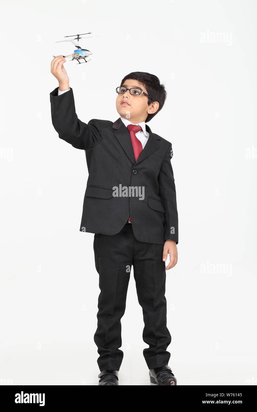 Boy pretending to be a businessman playing with model airplane Stock ...