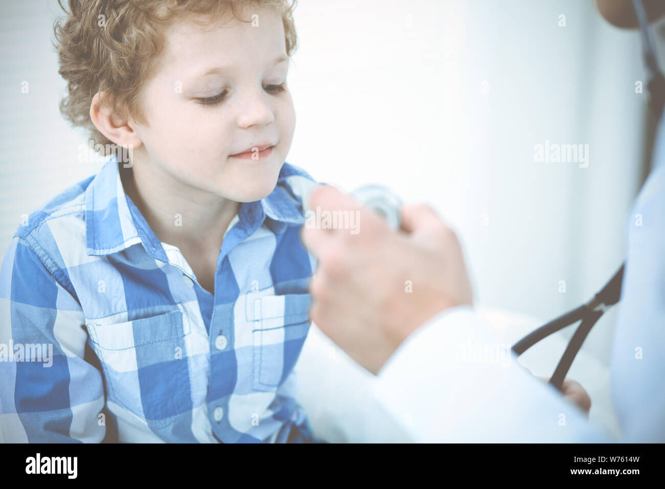 Doctor and patient child. Physician examining little boy. Regular ...