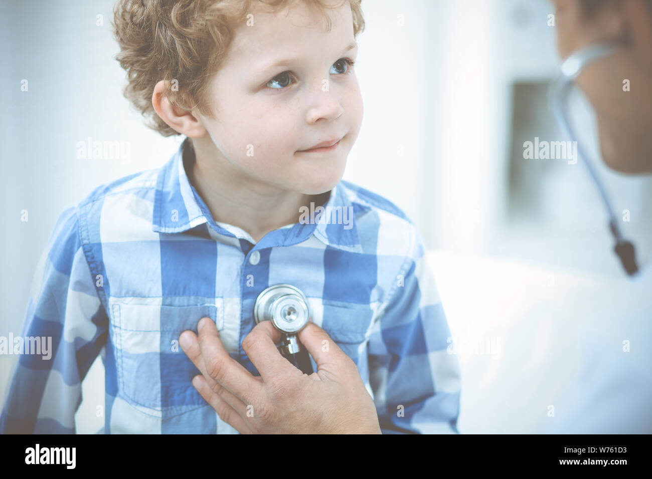 Doctor and patient child. Physician examining little boy. Regular ...