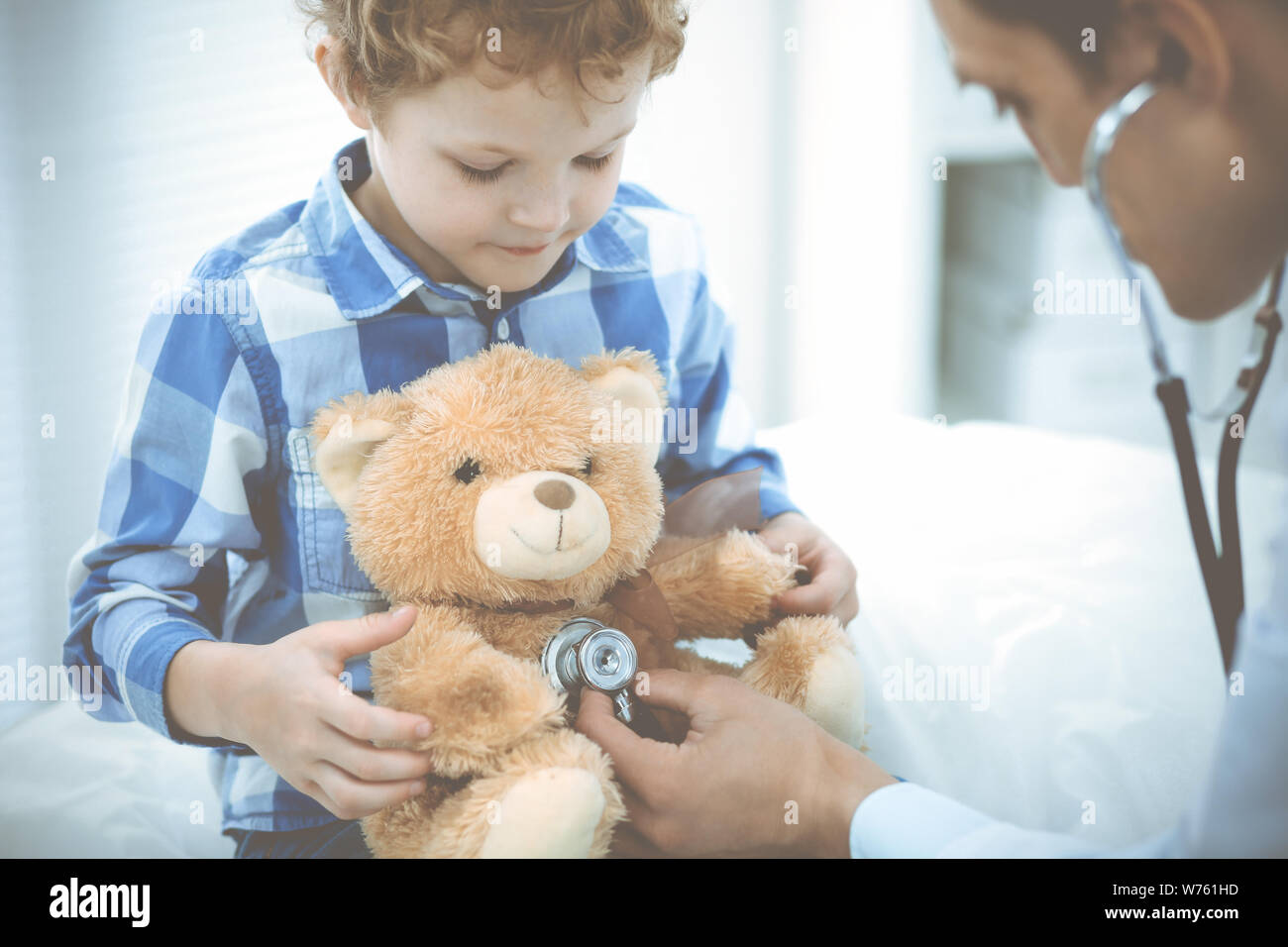 Doctor and patient child. Physician examining little boy. Regular ...