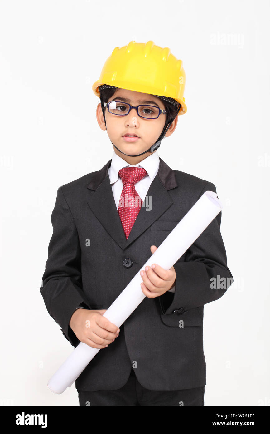Boy pretending to be an architect and holding a blueprint Stock Photo ...