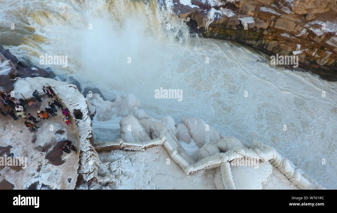 Tourists visit the Hukou Waterfall scenic spot with icicles on the ...