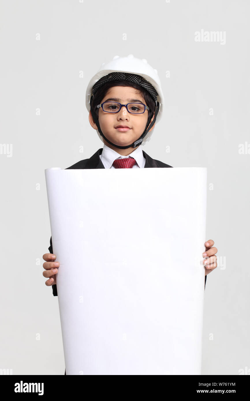 Boy pretending to be an architect and holding a blueprint Stock Photo ...