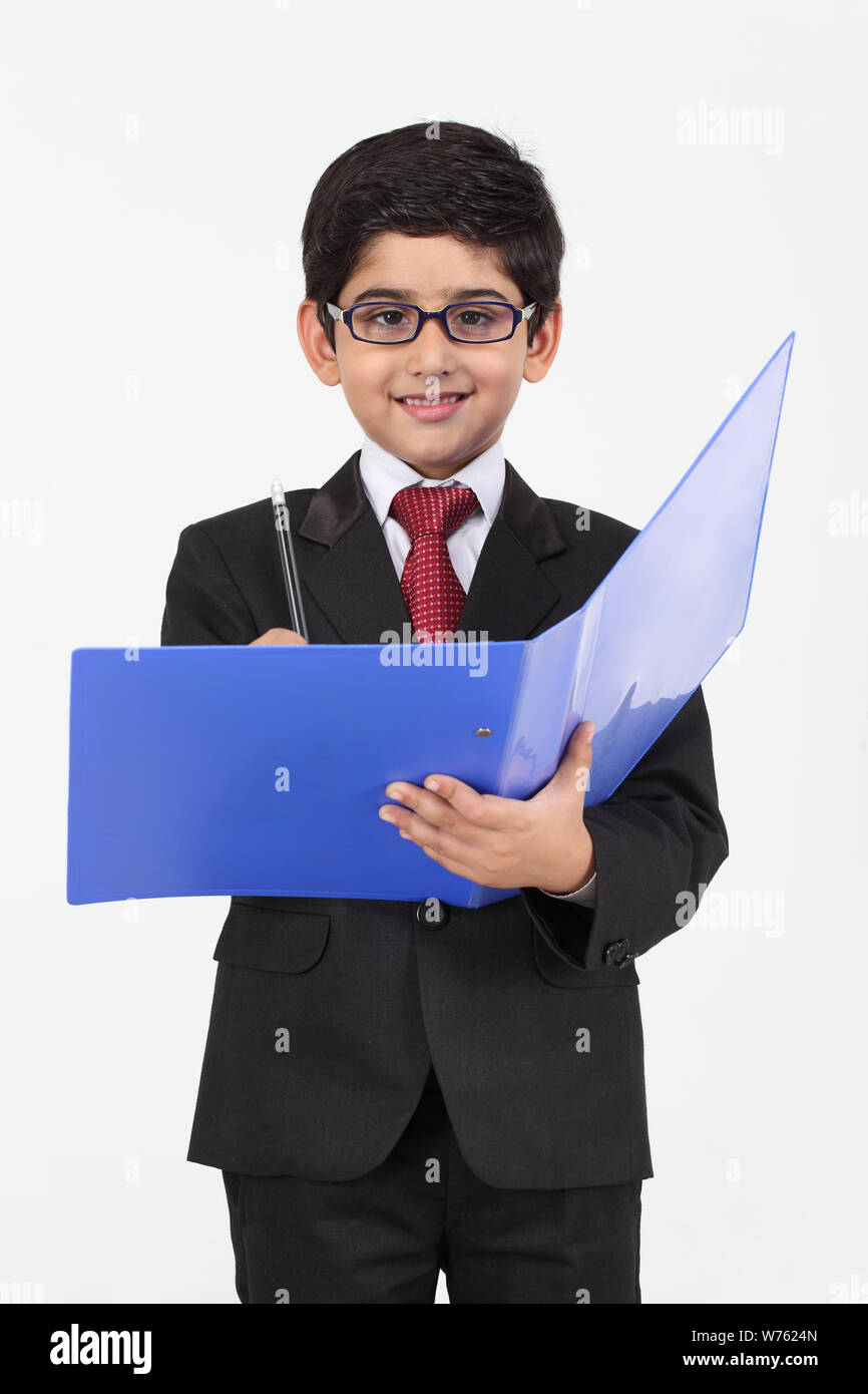 Boy pretending to be a businessman writing on file Stock Photo - Alamy