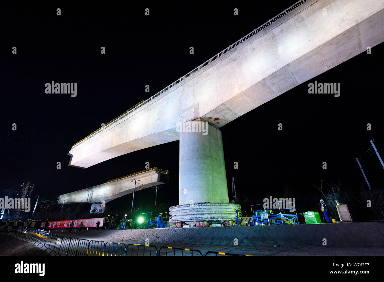 A girder bridge weighing 7,000 tonnes is rotated 28 degrees clockwise ...