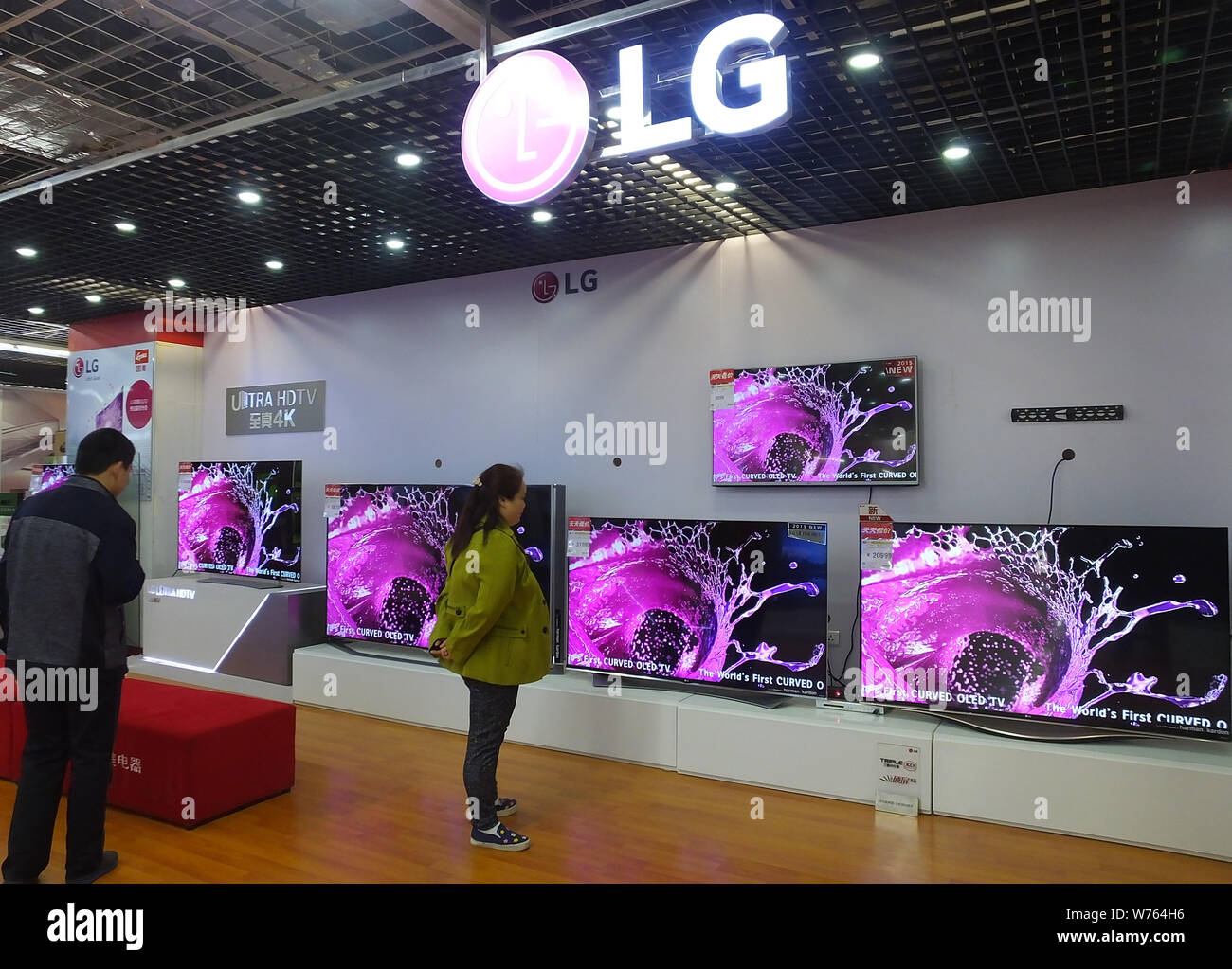--FILE--Customers shop for televisions of TCL at a home appliance store ...