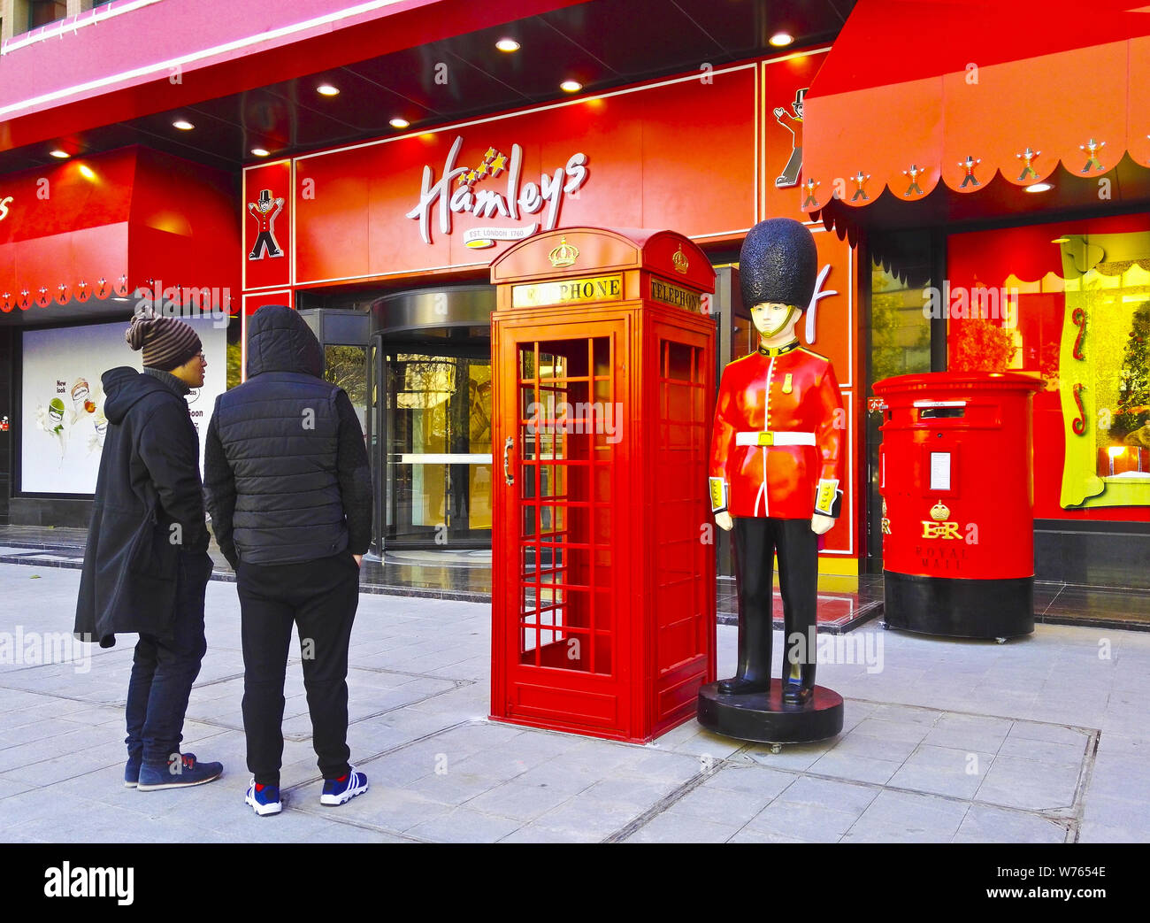 Pedestrians look at the newly-opened flagship store of British toy ...