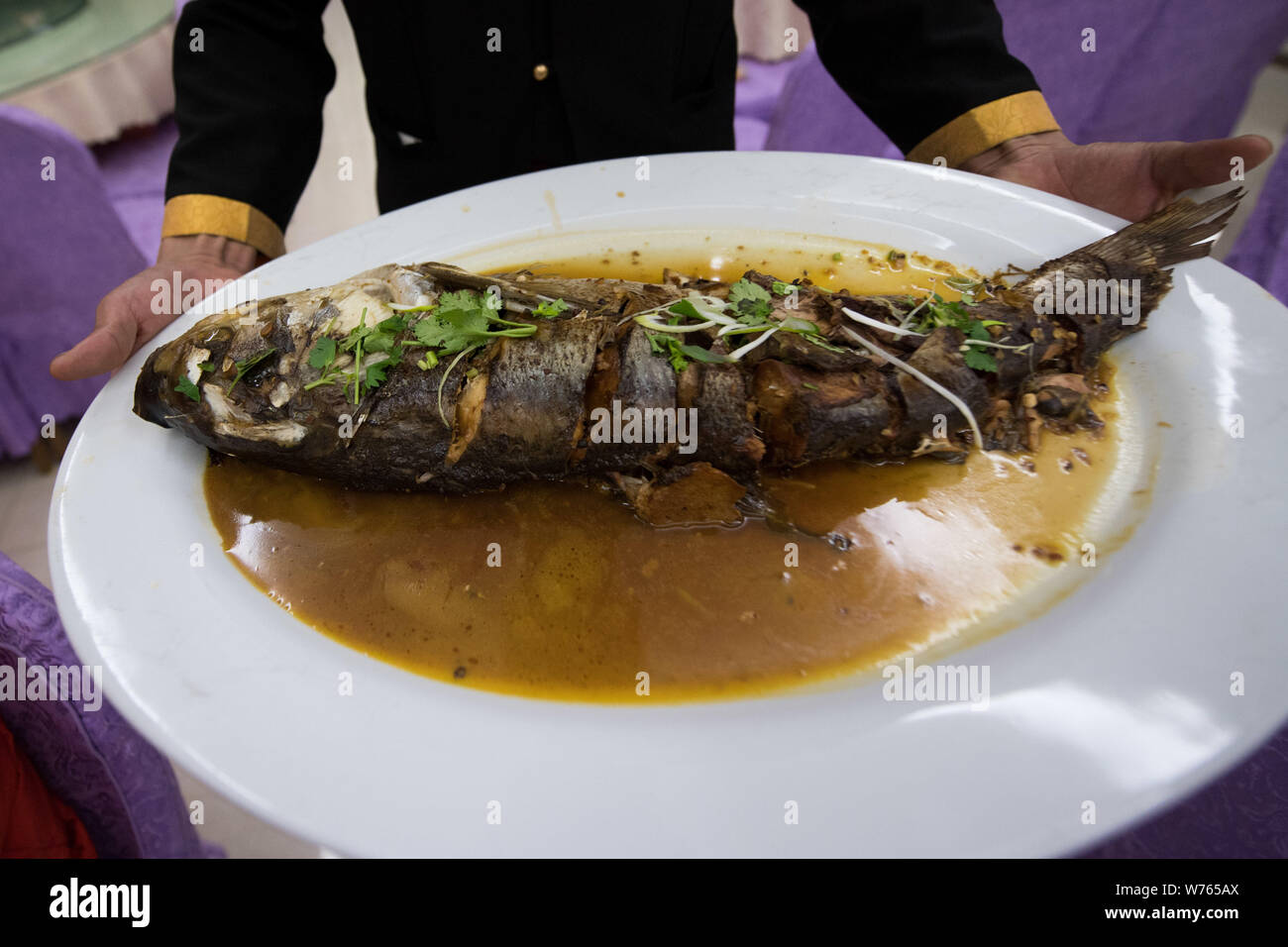 Fish harvested from the Chagan Lake winter fishing season is served at ...