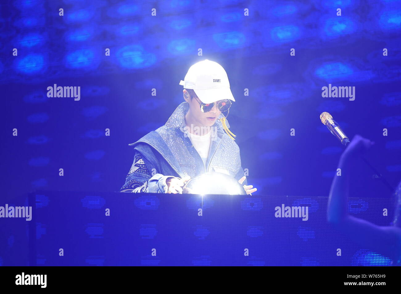 Chinese singer Li Yuchun or Chris Lee performs at a concert to release ...