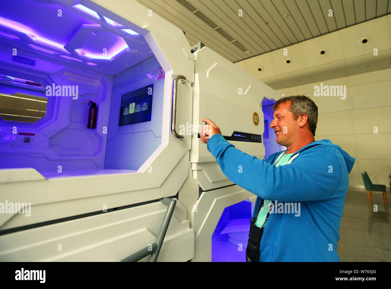 A foreign passenger takes photos of sleeping capsules in the arrival ...