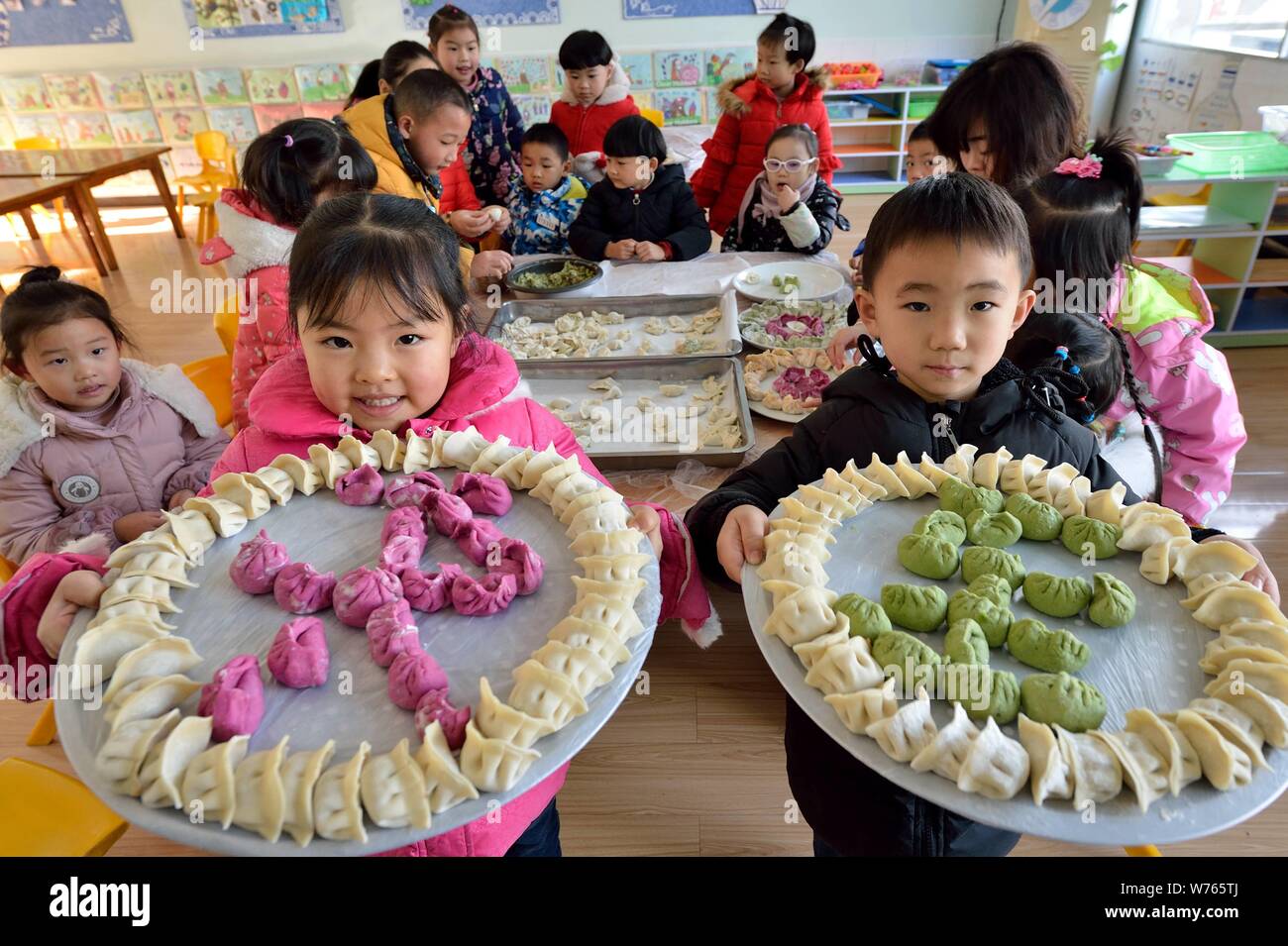 Chinese children show dumplings they made with their teacher to ...