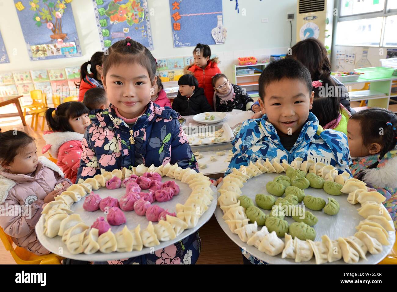 Chinese children show dumplings they made with their teacher to ...