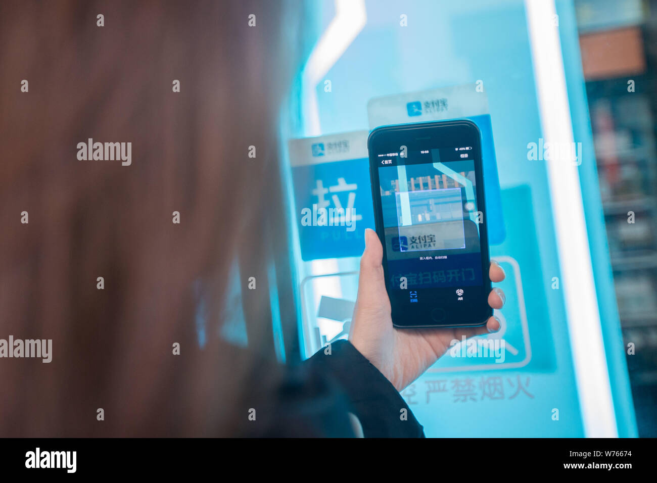 A customer scans a QR code via mobile payment service Alipay of Alibaba ...