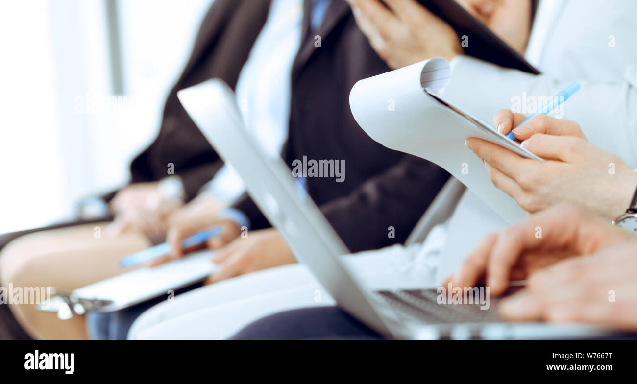 Business people working at meeting or conference, close-up of hands ...