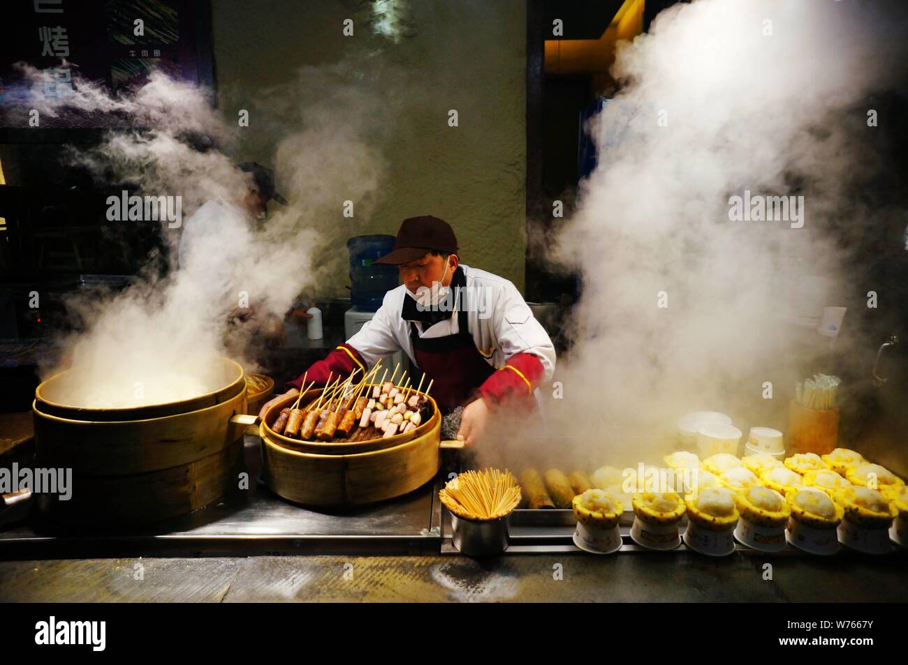 --FILE--A chef serves snacks at Wide and Narrow Alleys (KuanZhaiXiangZi ...