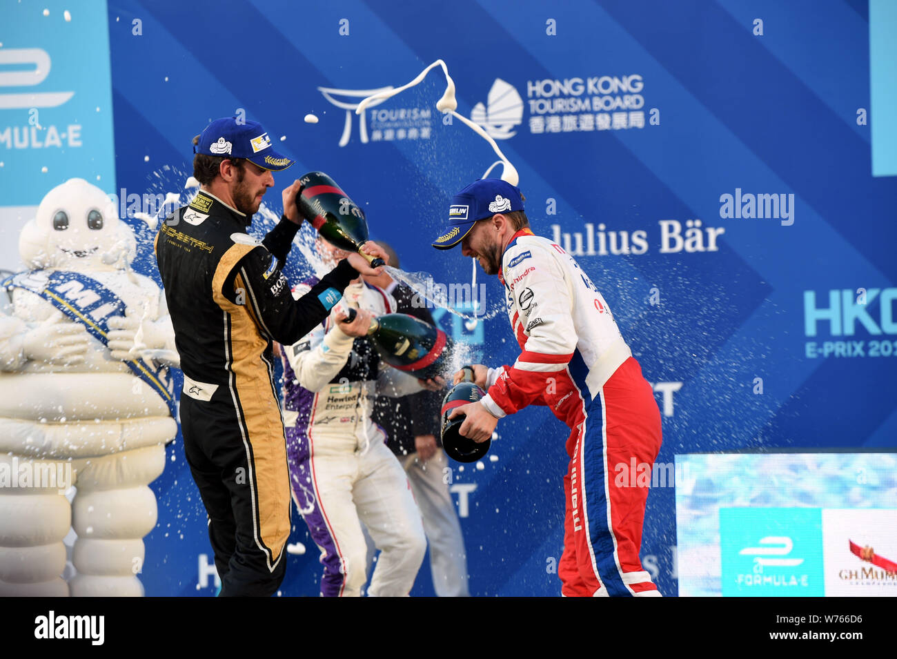 French racing driver Jean-Eric Vergne, left, of Techeetah, sprays ...