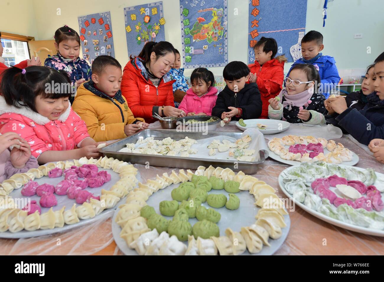 Chinese children make dumplings with their teacher to celebrate the ...